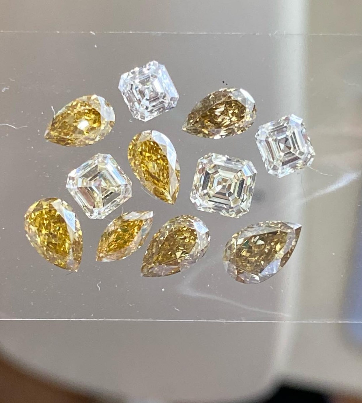 stunning layout featuring 11 pieces of mixed fancy color diamonds ...