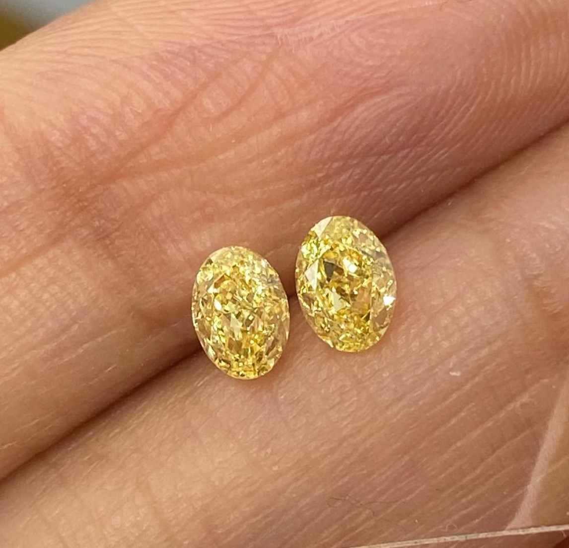 Elevate your style with this stunning pair of natural fancy intense ...